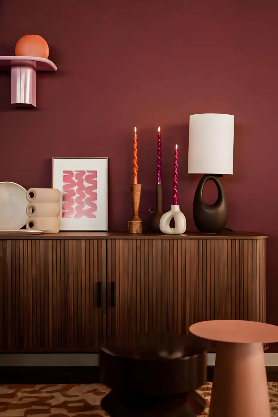 Bold Maroon Accent Wall with Fluted Cabinet and Warm Wooden Accents